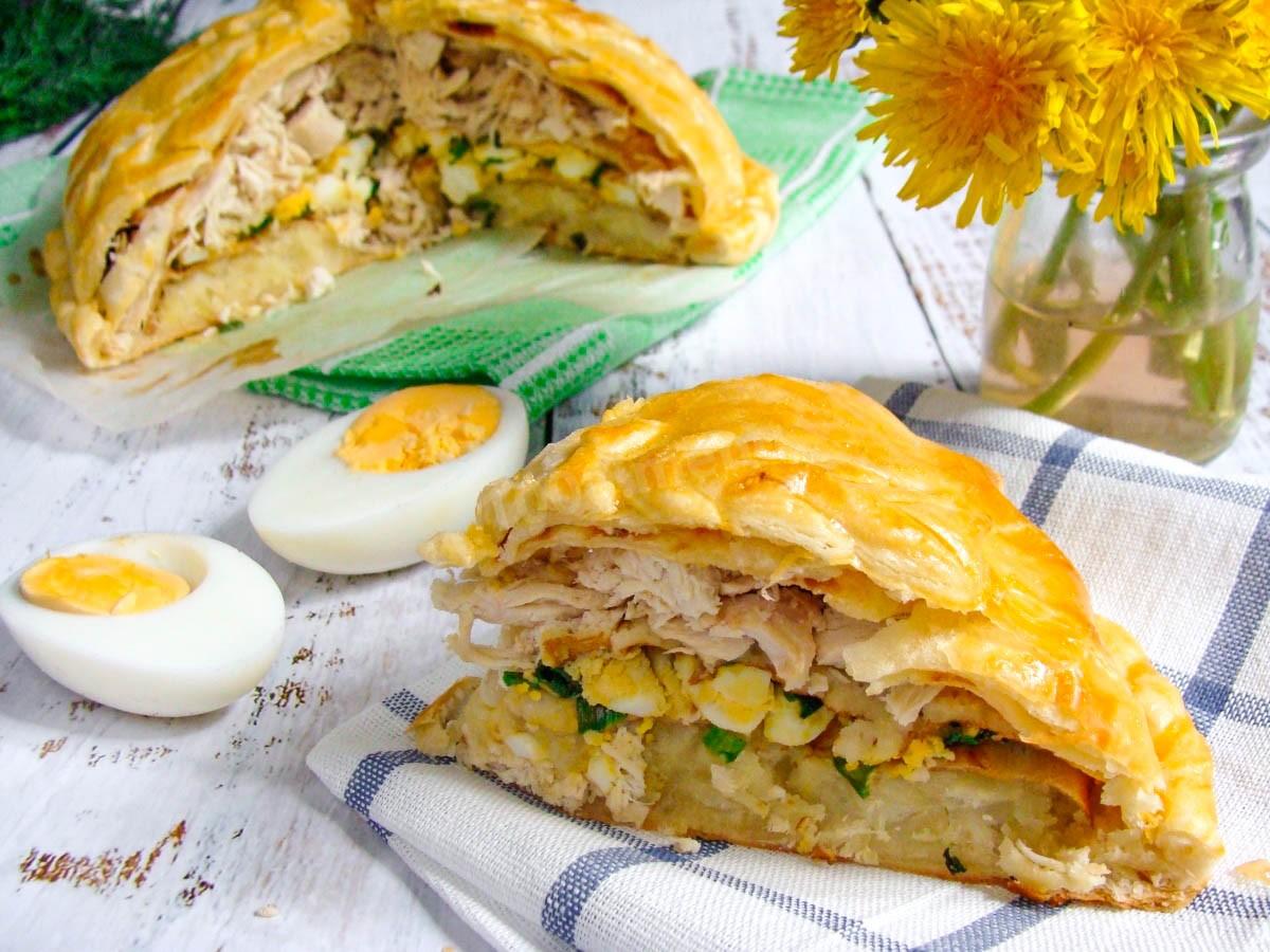 Kurnik with potatoes and chicken made from puff pastry in the oven ...